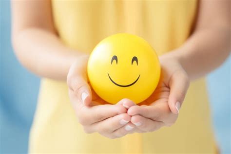 Premium Ai Image Woman Hand Holding Happy Smile Emoji Sphere Position
