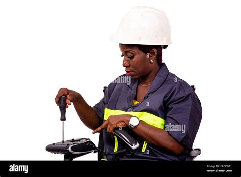 Portrait Of A Beautiful Female Technician Wearing Work Uniform And White Safety Helmet Repairing