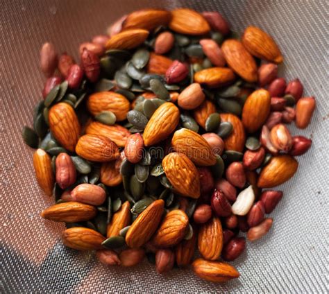 A Mixture Of Wet Washed Nuts And Seeds On The Sieve Peanuts Pumpkin