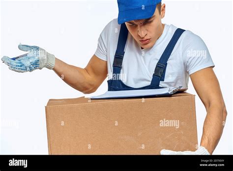 Man Worker With Box In Hands Delivery Loading Service Work Light Background Stock Photo Alamy