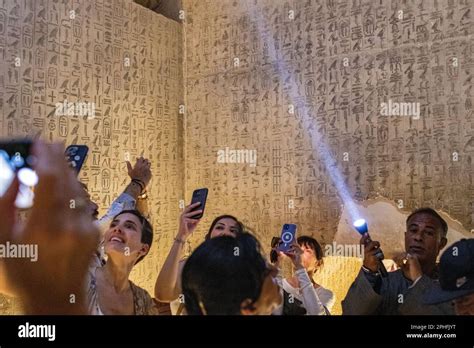 People Tourists Taking Photos Of The Hieroglyphics In An Underground