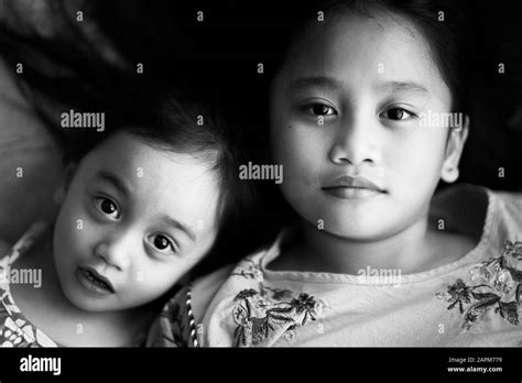 Portrait Of Asian Siblings Sisters Looking With Cute Face Looking At