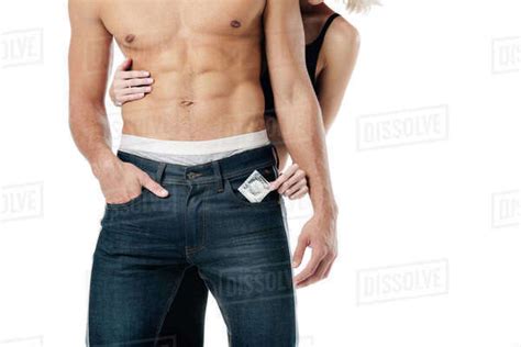 Cropped View Of Woman Hugging Shirtless Man From Behind And Holding Condom Isolated On White