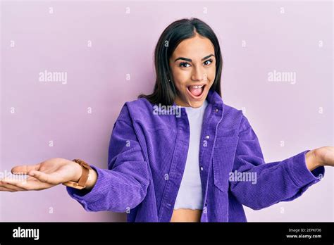 Young Brunette Woman Wearing Casual Clothes Smiling Cheerful Offering
