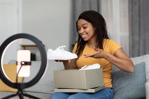 Premium Photo | Unboxing video black female blogger unpacking parcel with new shoes recording ...