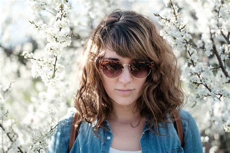 Portrait Of Woman With Sunglasses In The Springtime By Stocksy