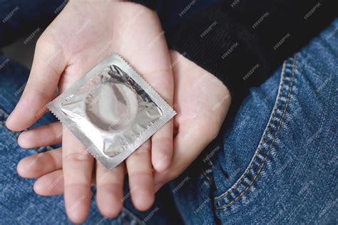 Premium Photo Condom Ready To Use In Female Hand Give Condom Safe Sex