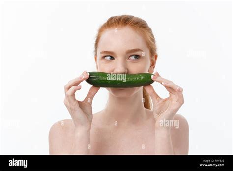 Cheerful Happy Beautiful Girl With Cucumber On Her Hand Isolated On
