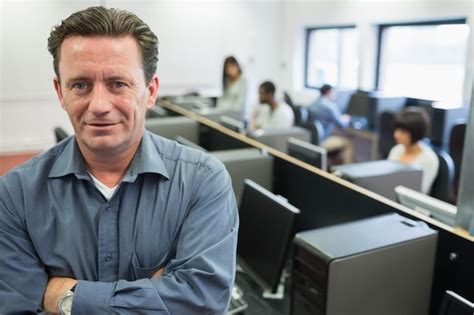 Premium Photo Man Smiling At Front Of Computer Class