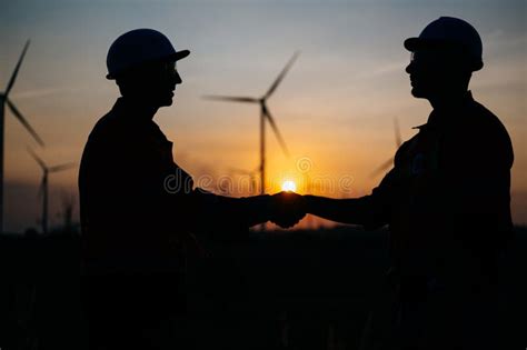 Engineers Technicians Working With Teamwork At Wind Turbine Field Stock