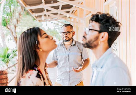 Man Discovering His Cheating Girlfriend Kissing Another Man In The