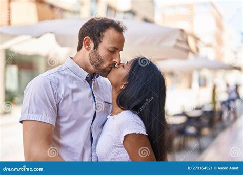 Man And Woman Interracial Couple Hugging Each Other And Kissing At