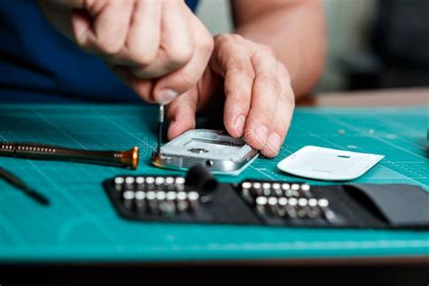 Electronics Repair Service Technician Disassembling Smartphone For