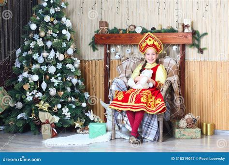 Girl In Russian Traditional Costume Sits In Chair Royalty Free Stock