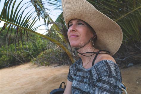 Woman Smiling In Straw Hat Sitting On Tropical Beach Stock Image