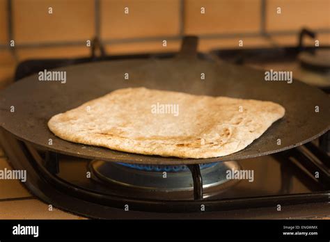 Roti Prata Cooking On Hot Flat Iron Frying Pan Griddle Grill Under Mild