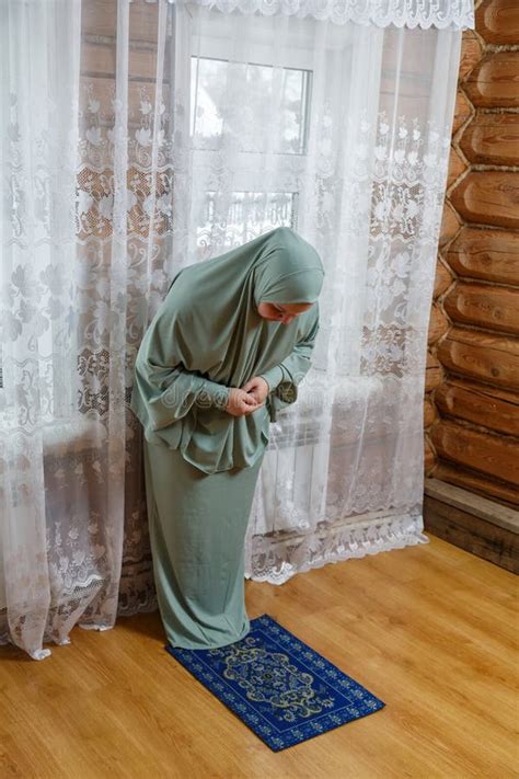 A Muslim Woman In A Light Khimar Performs Friday Prayers At Home Stock