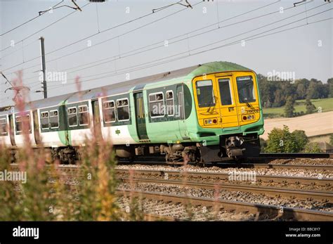 Passenger Train Class 319 In Southern Livery Speeding Through The