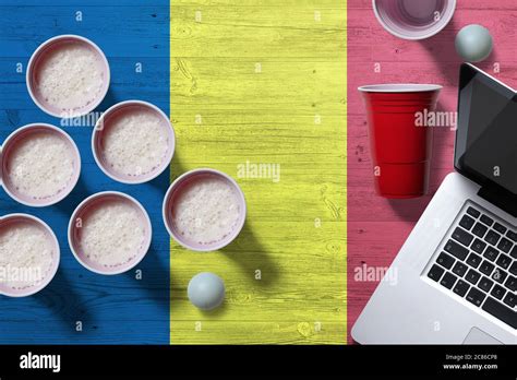 Romania Flag Concept With Plastic Beer Pong Cups And Laptop On National