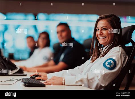 Group Of Security Data Center Operators Working In A Cctv Monitoring