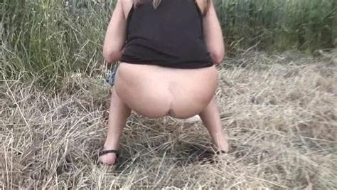 Blonde Emptying Her Bowels In Nature