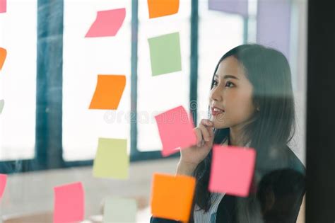 A Businesswoman Uses Post It Notes To Share Ideas Showcasing The Concept Of Brainstorming The