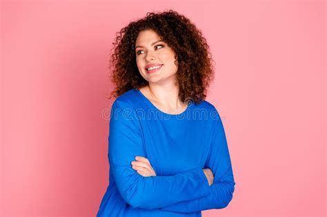Young Woman With Brunette Hair In Blue Sweater Smiling Against Pink