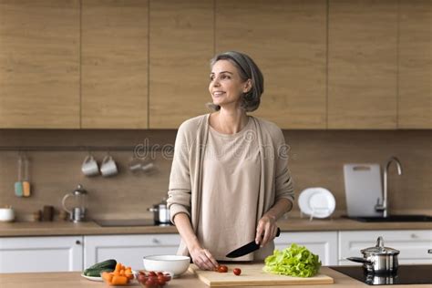 Smiling Dreamy Mature Housewife Enjoy Cooking In The Kitchen Stock Photo Image Of Dish Mature