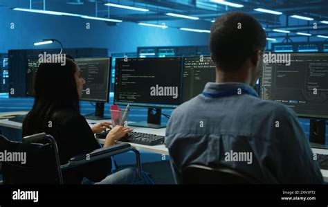 Person With Paraplegia Typing Data On Pc Doing Needed Adjustments In Supercomputers Server Farm