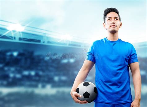 Asian Football Player Man In Blue Jersey Holding The Ball On The