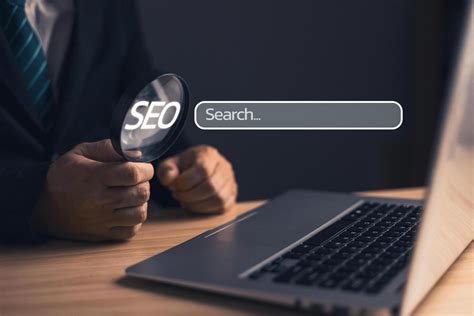 businessman standing in suit holding magnifying glass searching