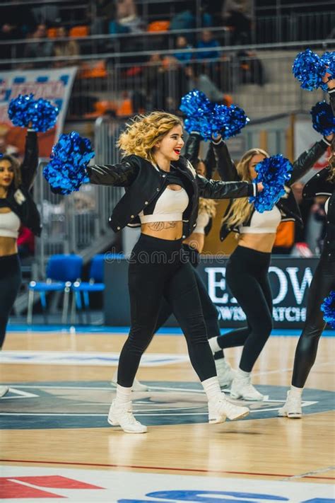 Cheerleaders Performing Dance Routine In Modern Sports Arena With