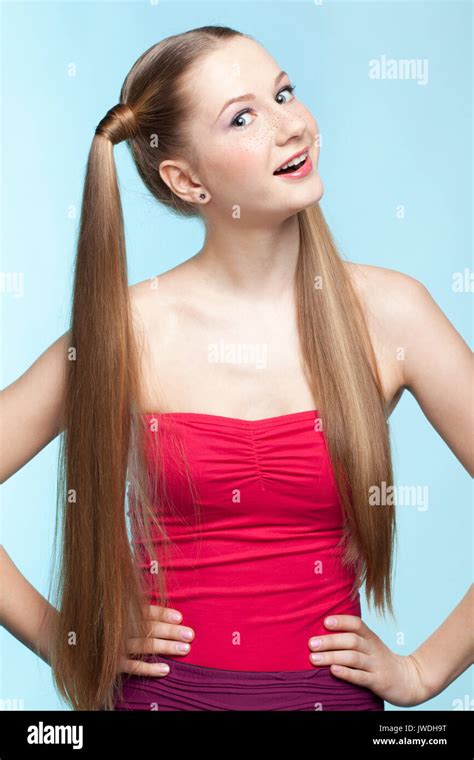 Beautiful Playful Freckled Girl In Red Dress On Blue Background Stock