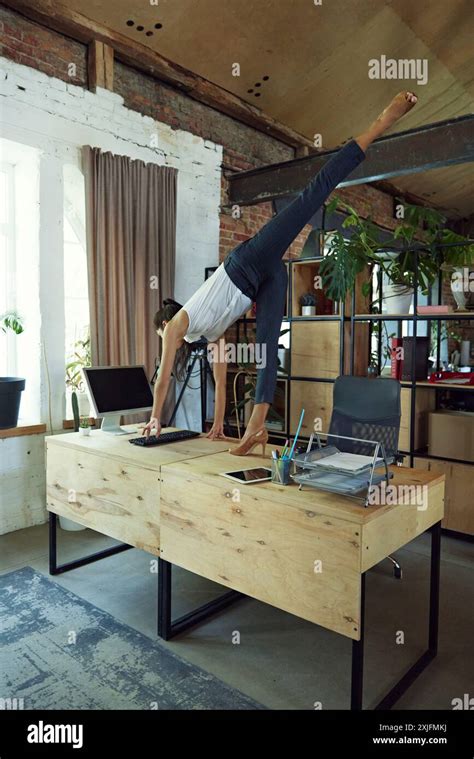 Combination Of Work And Exercises Woman Standing On Desk Working With