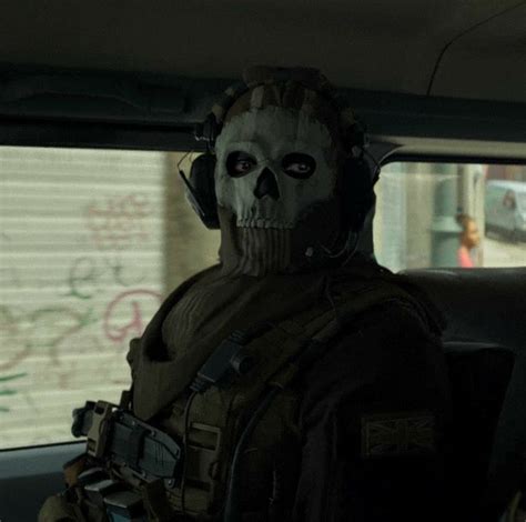 A Person In A Car With Headphones And A Skull Face On The Back Seat