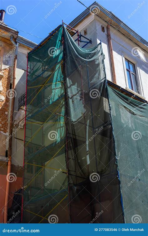 Building With Scaffolding Covered With White Scaffold Mesh Royalty Free