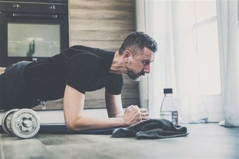 Premium Photo Man Practicing Plank Exercise At Home