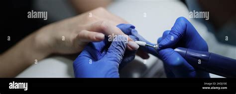 Manicurist Doing Hardware Manicure To Young Girl In Spa Salon Stock