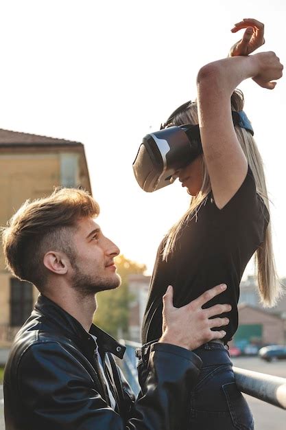Premium Photo Man Looking At Girlfriend Wearing Vr Glasses