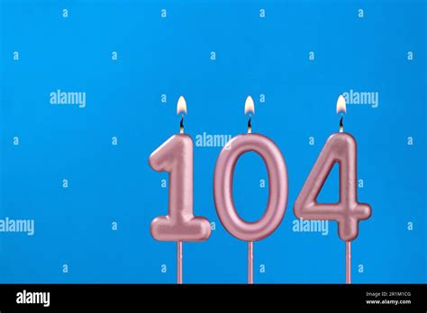 Candle number 104 - Birthday in blues foamy background Stock Photo - Alamy