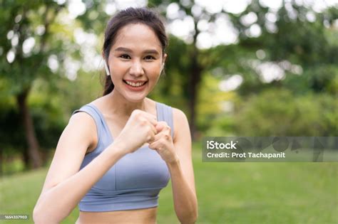 Fitness Asian Girl In Tight Sportswear Doing Exercises And Punching