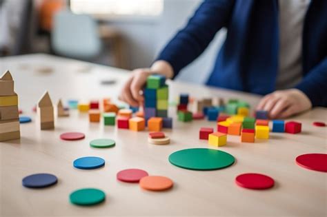 A Person Teaching Math Using Manipulatives Like Blocks Or Counters