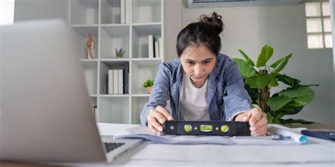 Woman Engineer Using Level Tool For Ensuring Accuracy In Project