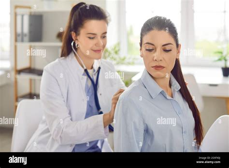 Doctor Uses Stethoscope Doing Regular Checkup Examine For Female
