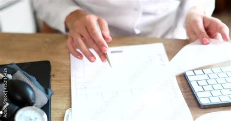Cardiologist Examines Electrocardiogram Of Patient With Disease Of