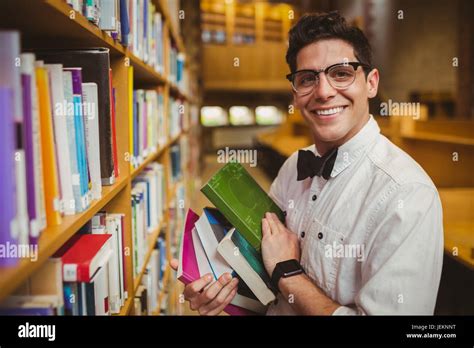Portrait Of Nerd Holding Books Stock Photo Alamy
