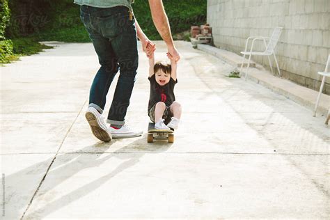 Father And Son Skateboarding Together By Stocksy Contributor Kate