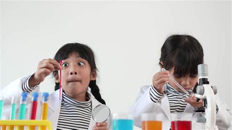 Slow Motion Shot Asian Siblings Wearing Coat Using The Device For