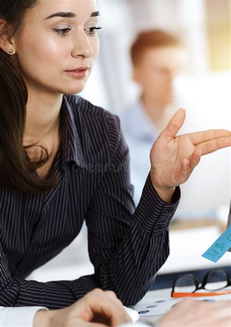Business Woman And Man Discussing Questions While Using Computer At