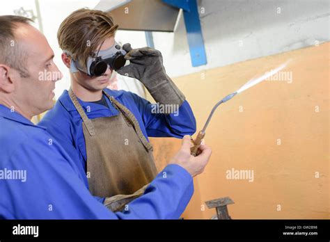 Two Men Using Blow Torch Stock Photo Alamy
